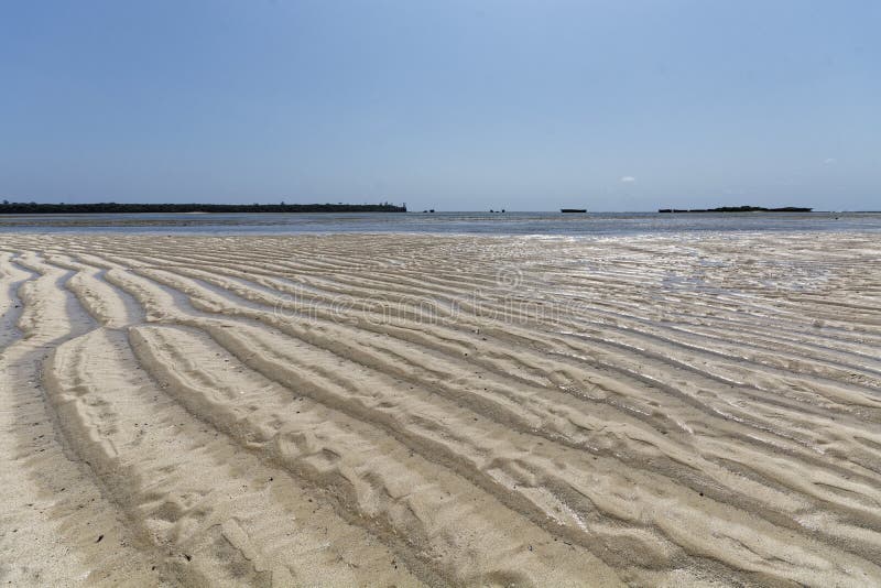 Sand Shore with Wave Pattern Ripples Lines with Water on a Sunny Day ...