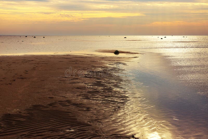 The Sand Spit with Footprints at Sunset Time on the Sea Stock Photo ...