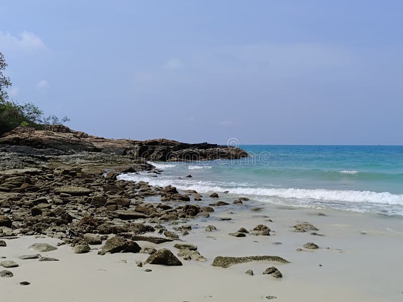 Sand stone and blue beach stock photo. Image of blue - 284389762