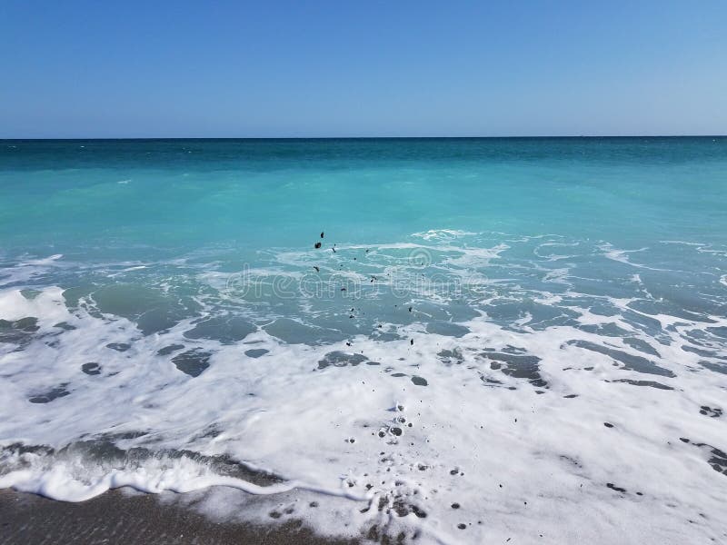Sand Thrown In The Air At Beach With Ocean Waves Stock Photo - Image of ...