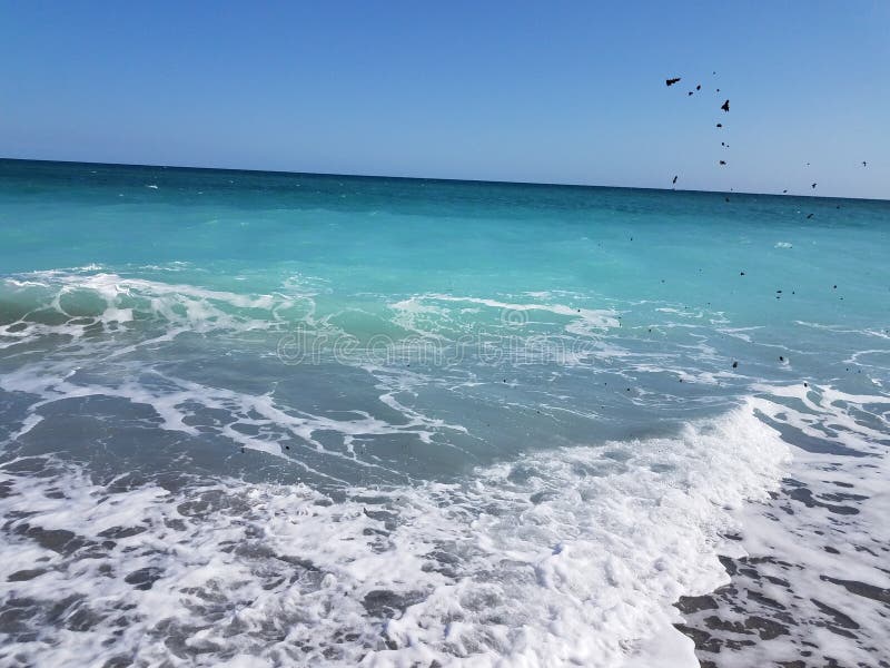Sand Thrown in the Air at Beach with Ocean Waves Stock Photo - Image of ...