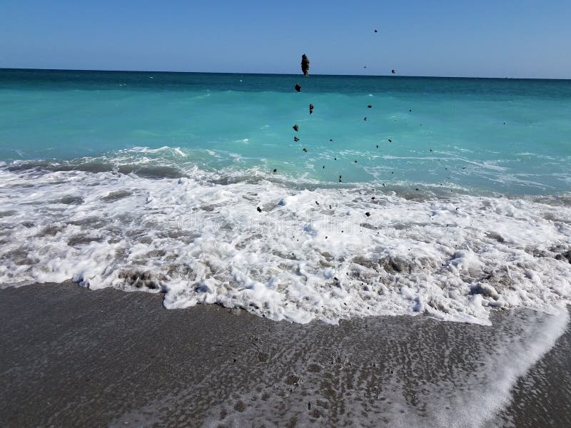 Sand Thrown in the Air at Beach with Ocean Waves Stock Photo - Image of ...