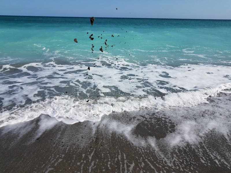 Sand Thrown in the Air at Beach with Ocean Waves Stock Photo - Image of ...
