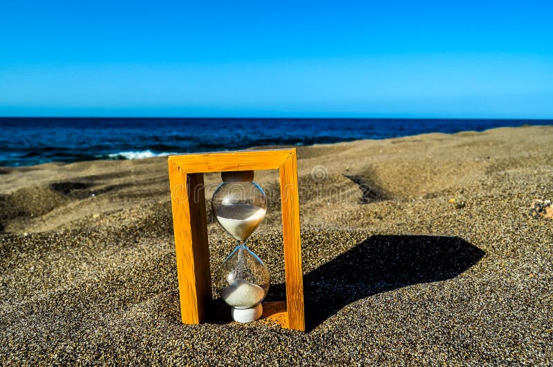 A Sand Timer is on the Beach, with the Sand Timer Showing the Time As ...