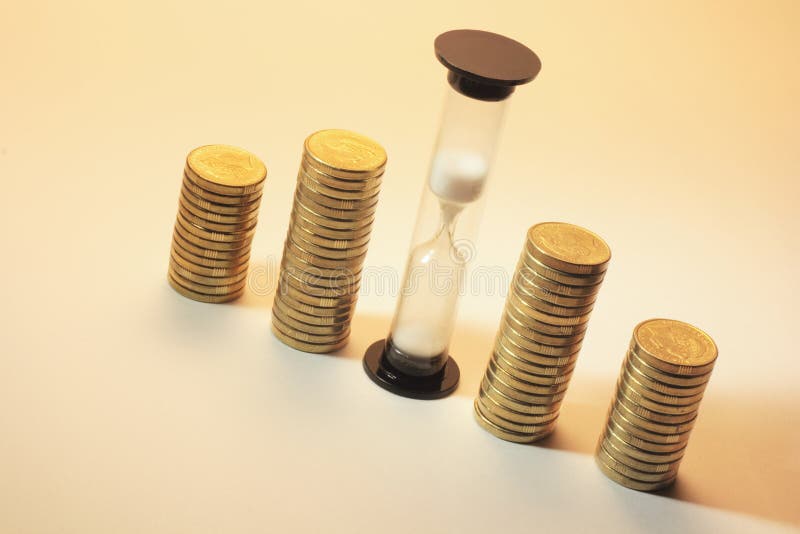 Sand Timer and Coins stock image. Image of reliability - 128857841