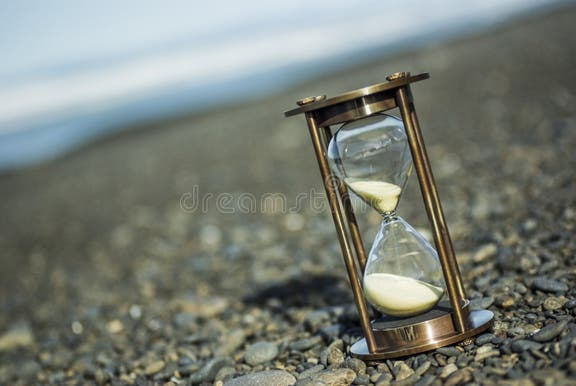Sand Timer on Pebble Beach stock image. Image of warming - 25585279