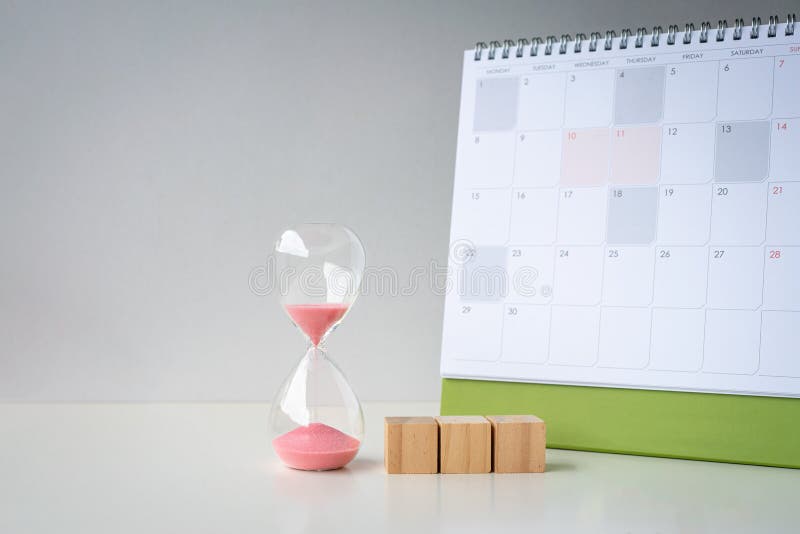 Sand Timer with Three Blank Wooden Toy Blocks Next To a Calendar Stock ...