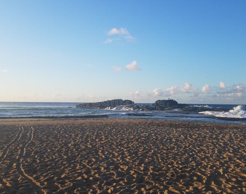 Sand and Waves at Beach in Isabela, Puerto Rico with Cross Stock Photo ...