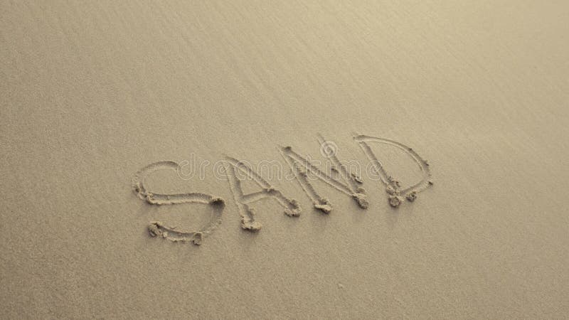 SAND Written on the Beach Sand Washed Aways by Waves. Stock Photo ...