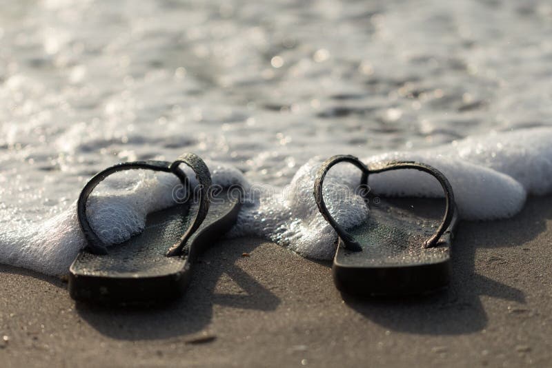 Sandals in the beach stock photo. Image of reflection - 73099028