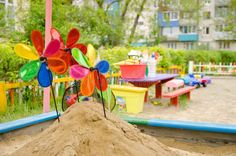 Sandbox with Wind Toys in the Sand on Playground Stock Image - Image of ...