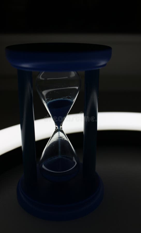 Sandglass with Falling Sand with Soft Backlight by Curved Lamp Stock ...