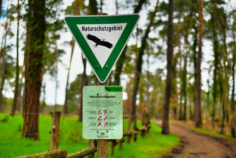 Green Triangular Sign with Eagle and Sign with Behavior Rules for ...