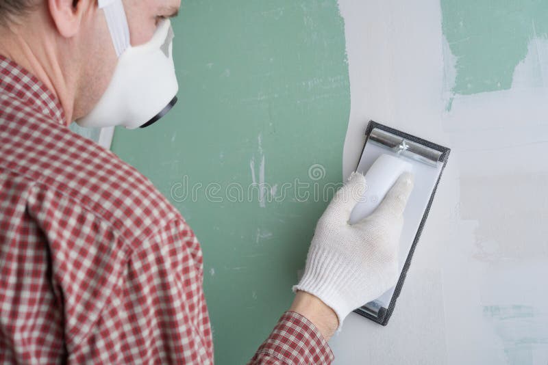 Sanding the drywall mud stock image. Image of constructor - 39219359