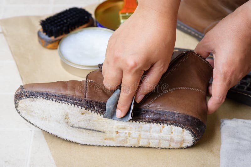 Reparing the torn boots stock image. Image of worn, footwear - 186336011