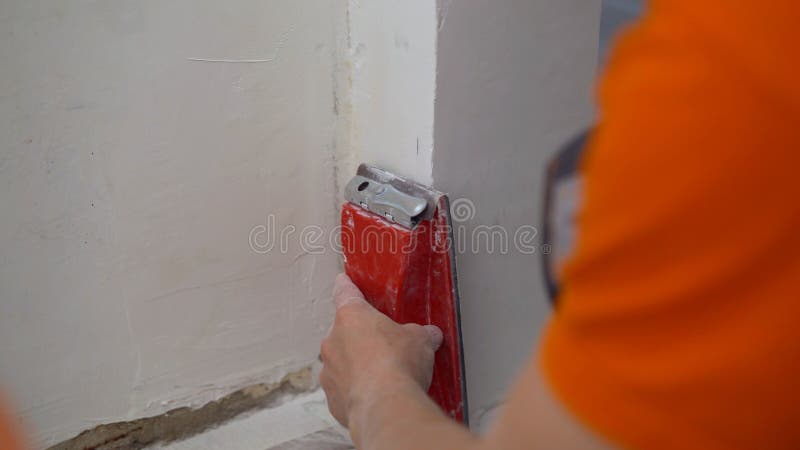 Sanding the Wall after Puttying. the Builder Grinds the Wall from ...