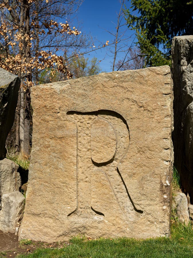 Sandstone Carved Letter R in a Park Stock Image - Image of stone, trees ...