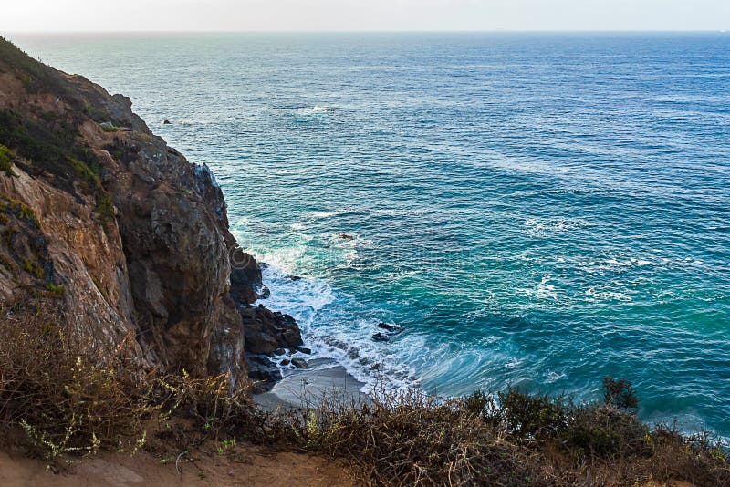Cliff Side View of Pacific Ocean at Sunrise with Sunrays Stock Photo ...