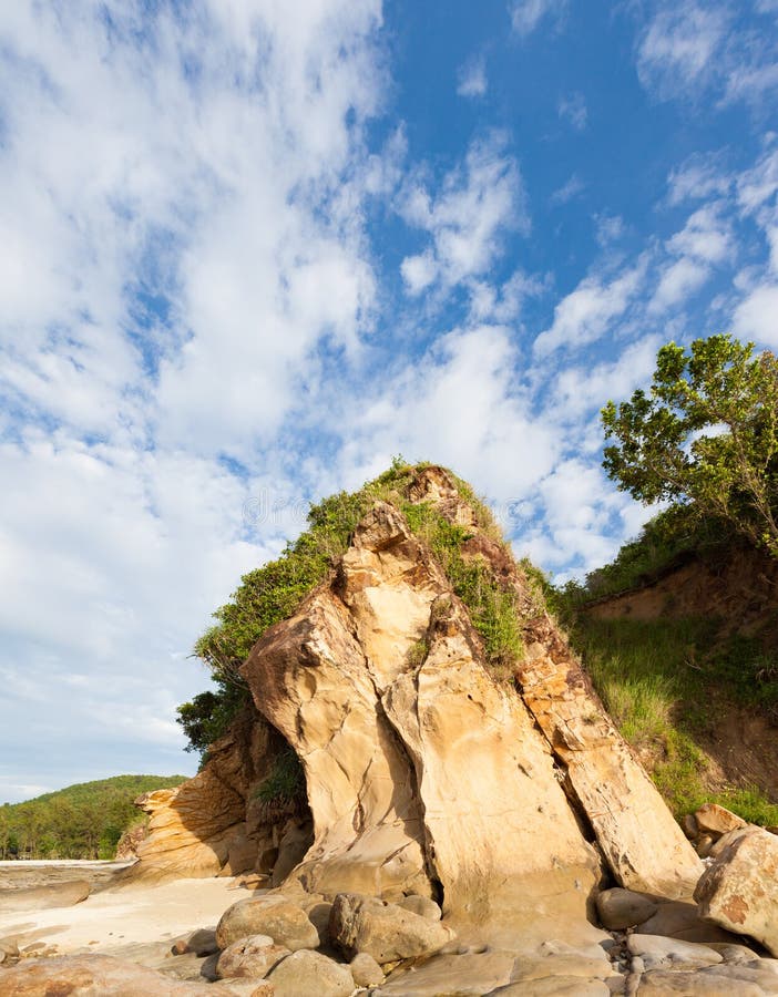 Sandstone rock at beach stock photo. Image of clouds - 82320482