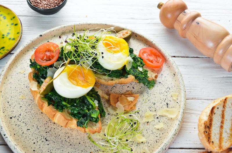 Sandwich with Spinach, Egg and Tomatoes. Croissant. Breakfast. in the ...