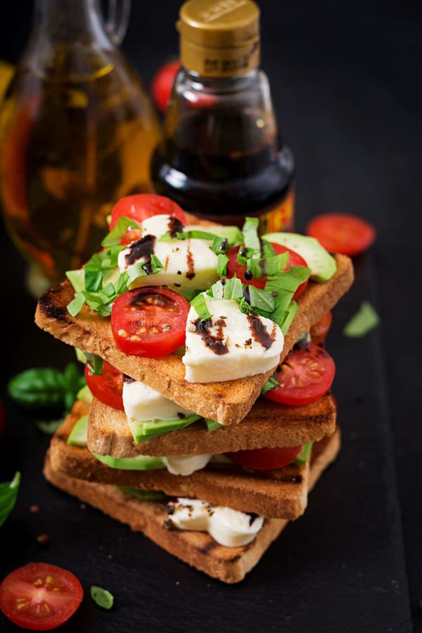 Sandwich Toasts with Tomatoes, Mozzarella, Avocado and Basil Stock ...