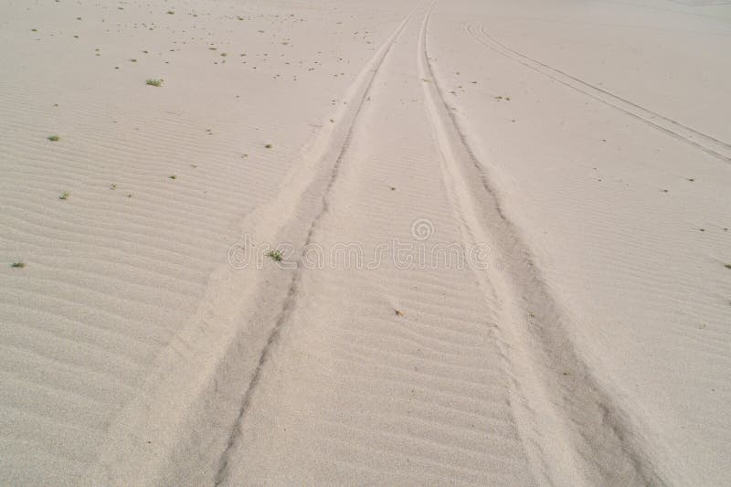 A Sandy Beach with a Few Footprints in the Sand Stock Image - Image of ...