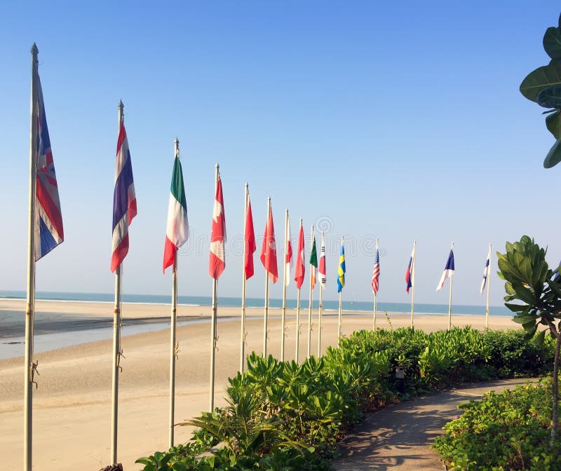Sandy Beach and Flags of the Different Countries on the Seashore ...