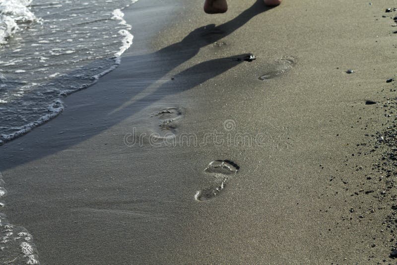 Sandy Beach with Footprints and Human Shadow Stock Image - Image of ...