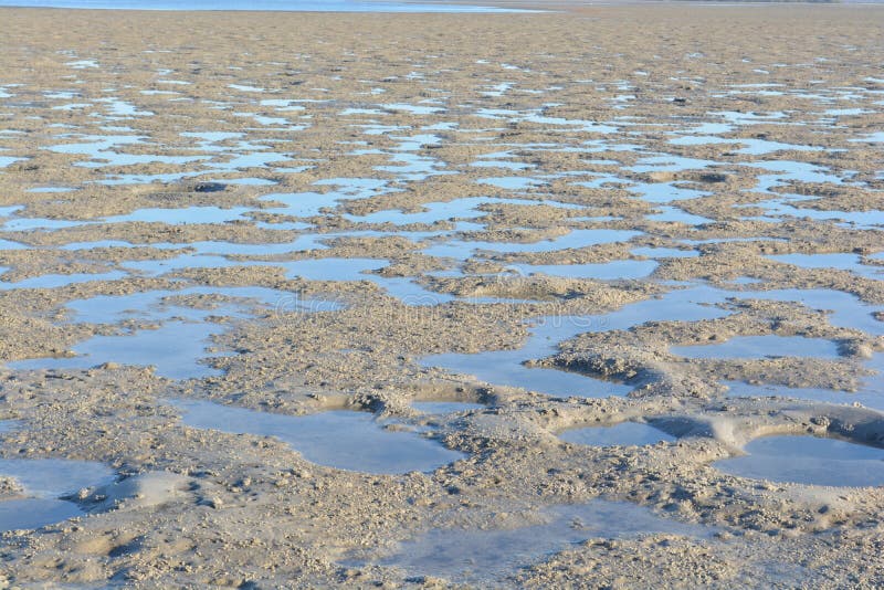 A Sandy Beach at Low Tide with Pools of Water Stock Photo - Image of ...