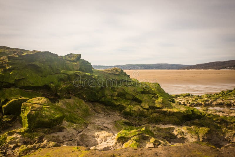 Sandy Beach with Low Tide Puddles and Rocky Foreground Interest and ...