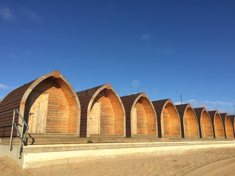 Rows of Contemporary Wooden Beach Huts on a Sandy Beach Stock Image ...