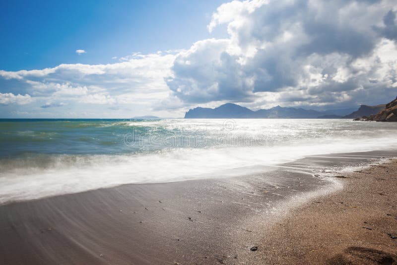 Sandy Beach with Mountains and Blue Sky Stock Image - Image of ...
