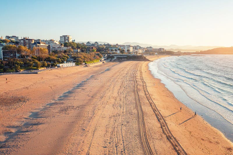 Sandy Beach Near the Sea, a Small Town on Shore, Sunset Stock Image ...
