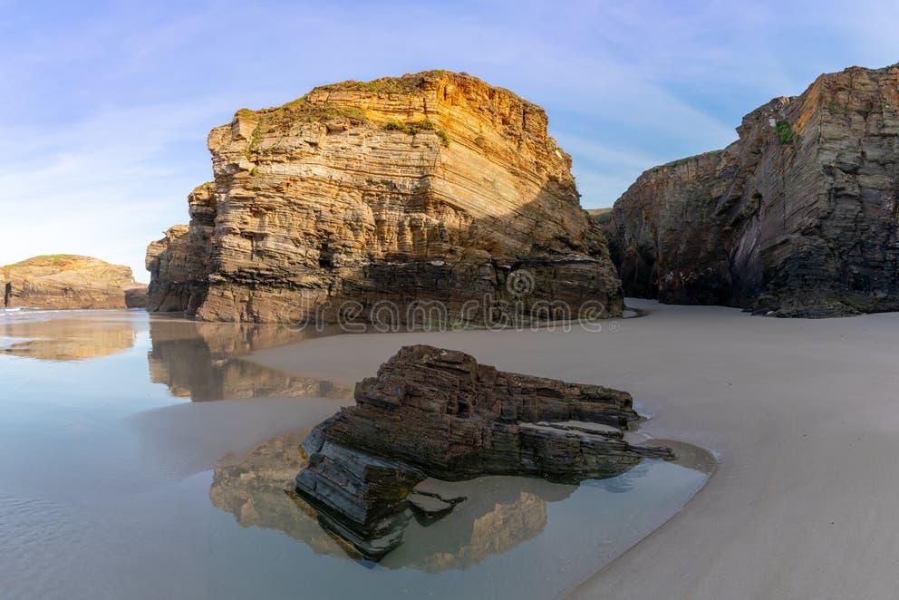 Sandy Beach Panorama with Tidal Pools and Jagged Broken Cliffs Behind ...