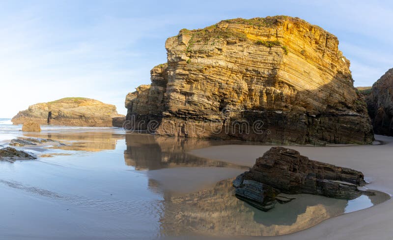 Sandy Beach Panorama with Tidal Pools and Jagged Broken Cliffs Behind ...