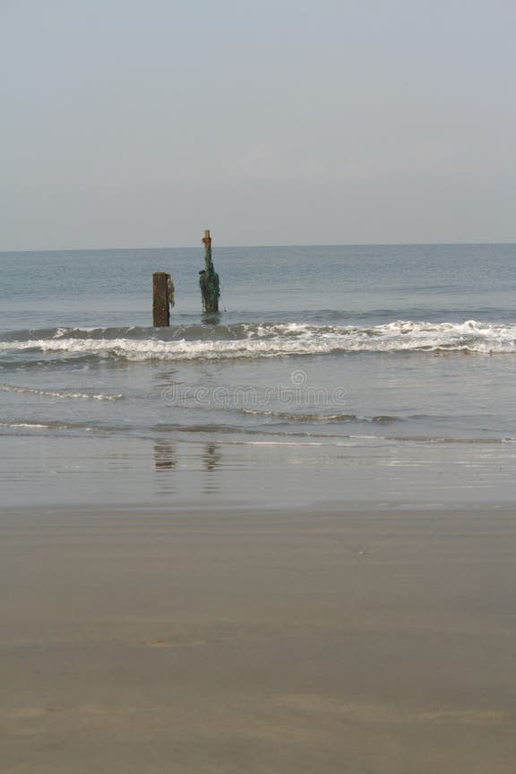 Sandy Beach with Pillars in the Water Stock Image - Image of tranquil ...