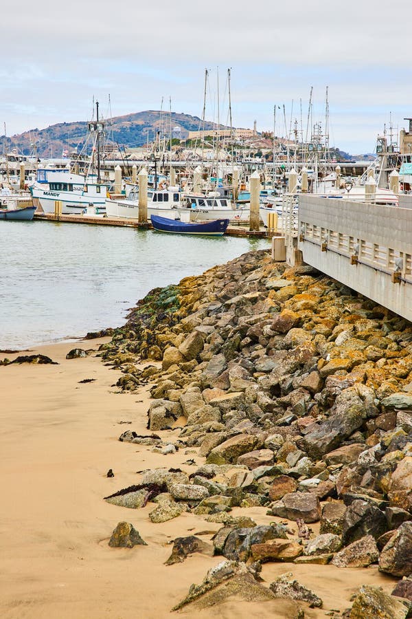 Sandy Beach with Rocky Coast Leading To Ships Docked on Piers Editorial ...