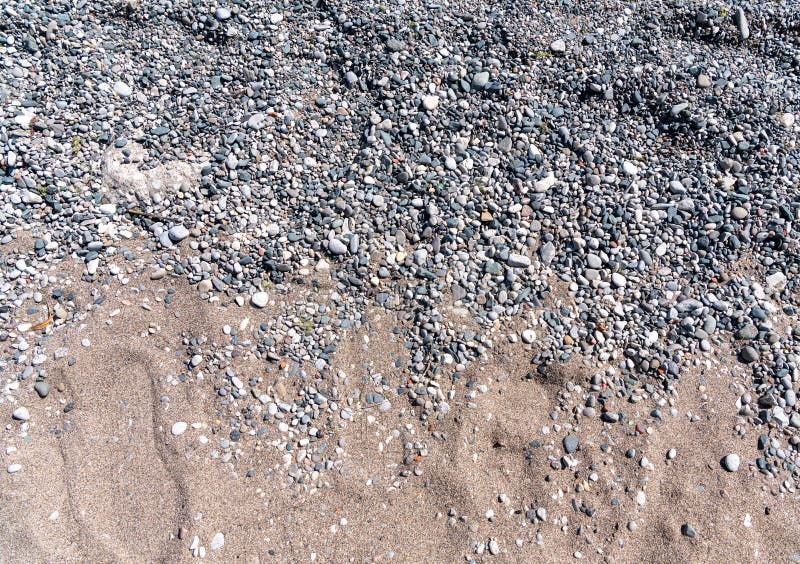 Sandy Beach with Small Pebbles Stock Image - Image of track, wall ...