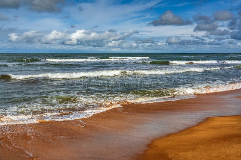 Sandy Beach, Small Waves and Blue Sky with Clouds Stock Photo - Image ...