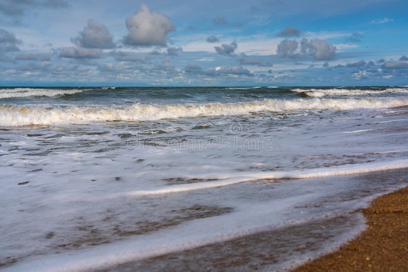 Sandy Beach, Small Waves and Blue Sky with Clouds Stock Photo - Image ...