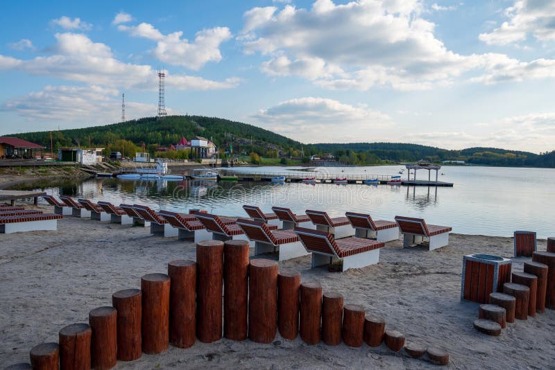 Sandy Beach with Sun Beds on the Background of a Pier, Boats and ...
