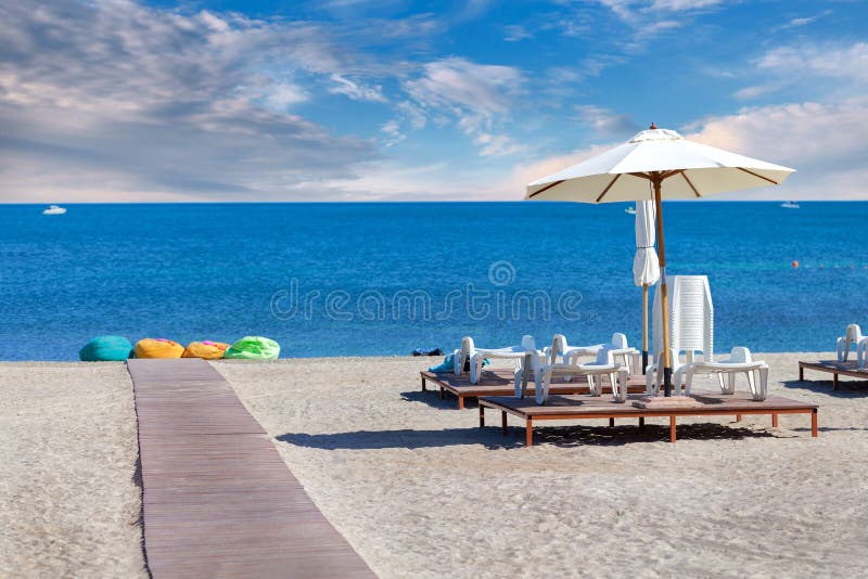 Sandy beach stock image. Image of parasol, sunbed, secluded - 31949693