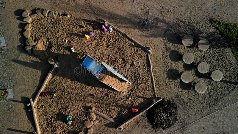 Sandy Children Playground Bordered by Tree Trunks and Sandstone ...