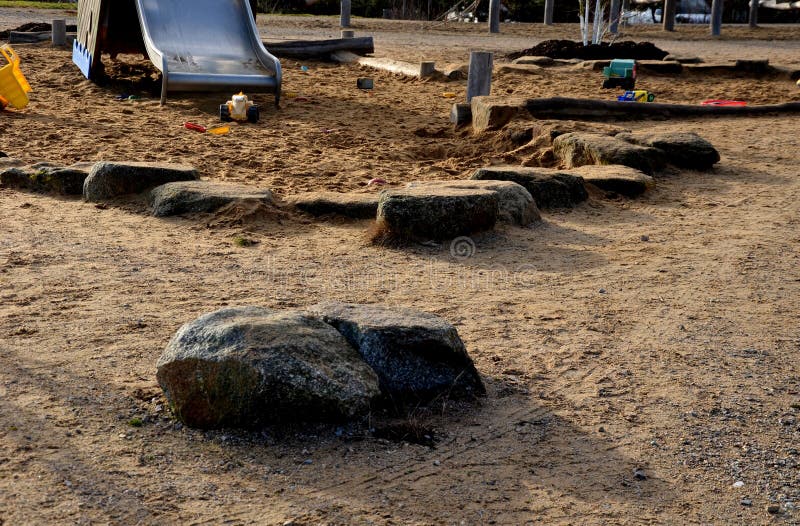 Sandy Children Playground Bordered by Tree Trunks and Sandstone ...