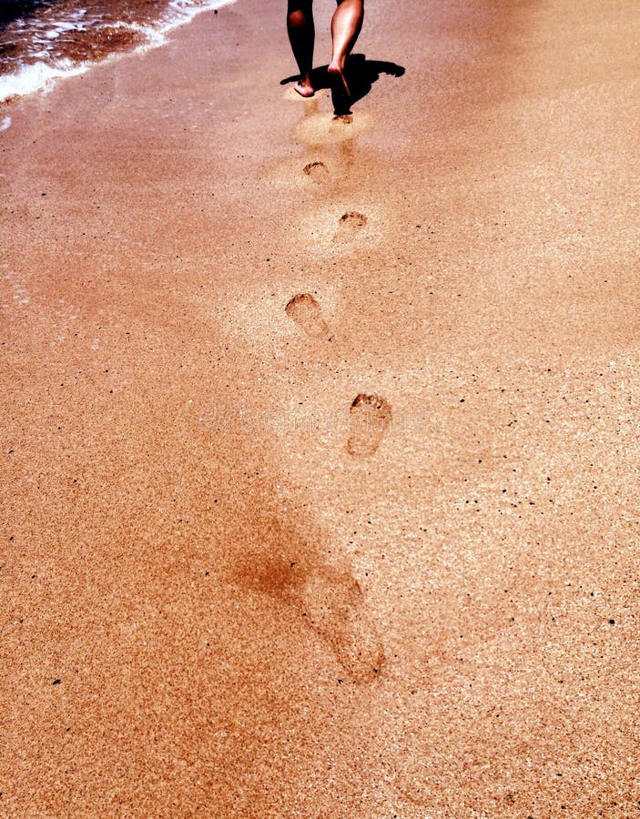 A Set of Sandy Footprints on the Beach about To Be Washed Off by the ...