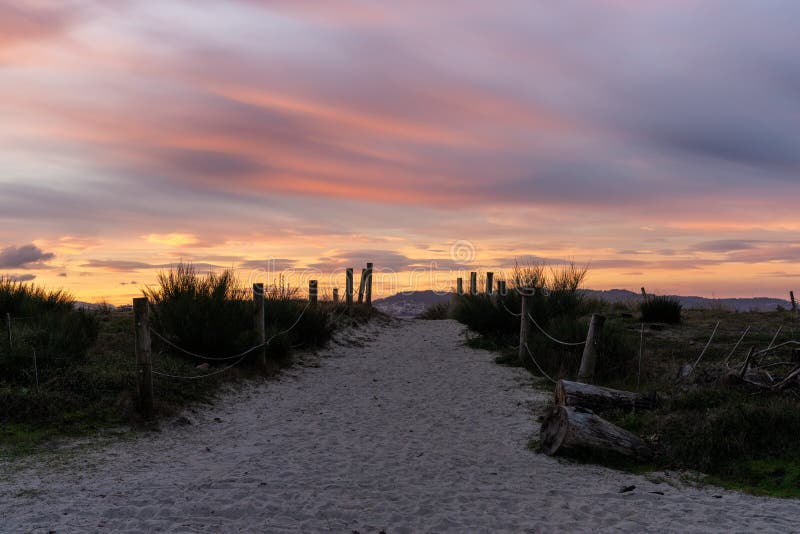 Sandy Path and Beach Access Leading through Dunes Under a Colorful ...