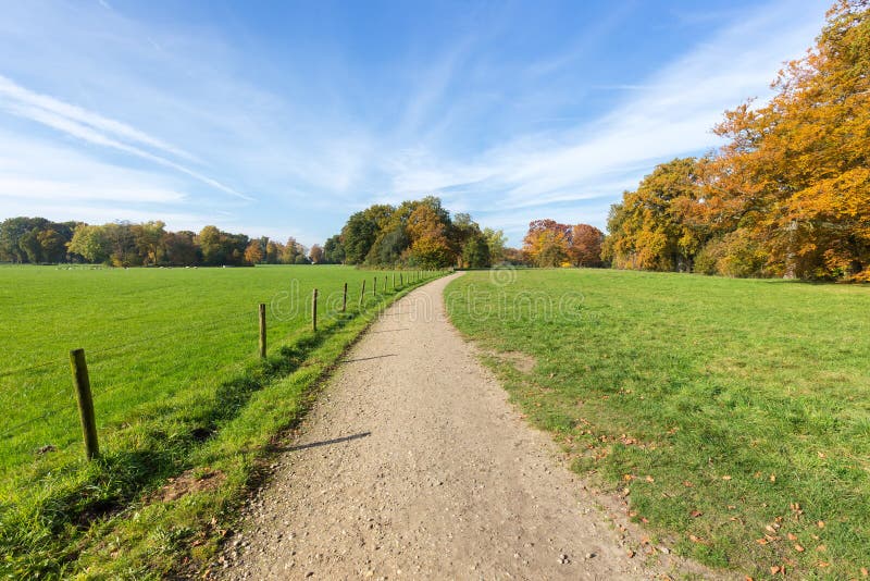 Sandy Path between Green Meadows with Autumn Colors Stock Photo - Image ...