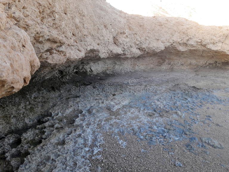 Sandy Rock Overhang with Wet Surface and Textured Geological Features ...