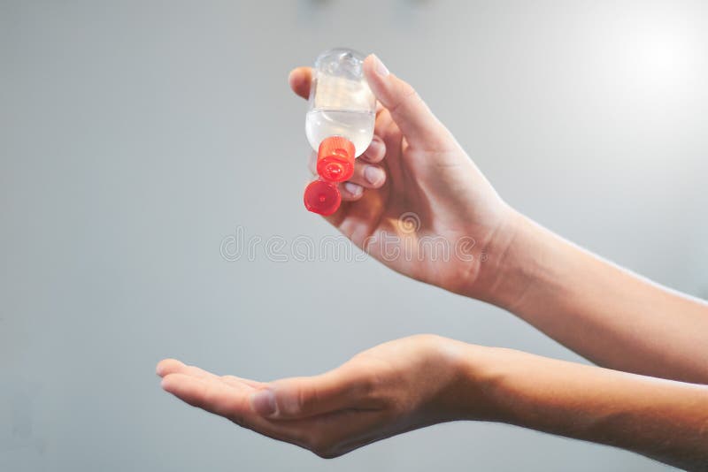Sanitizing Hands with Alcohol Stock Photo - Image of bottle, infection ...
