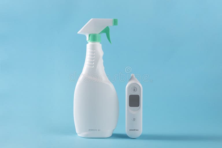 Sanitizing Spray and a Digital Thermometer on a Blue Surface Stock ...